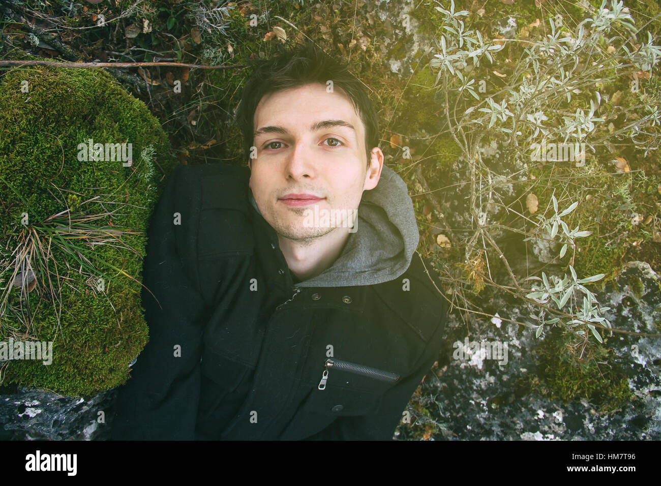 Young man having a break in nature Stock Photo - Alamy