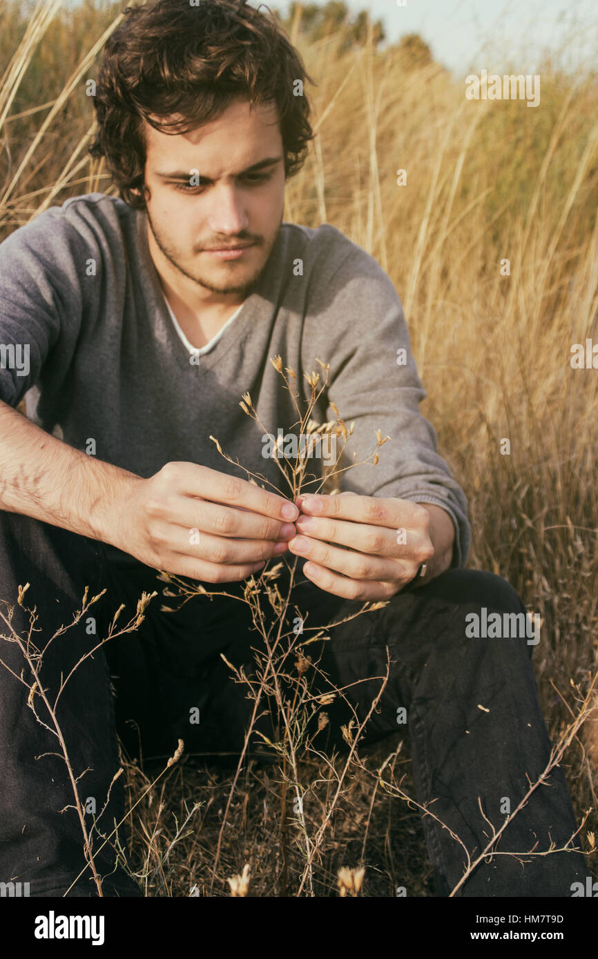 Young man alone in the fields at autumn Stock Photo - Alamy