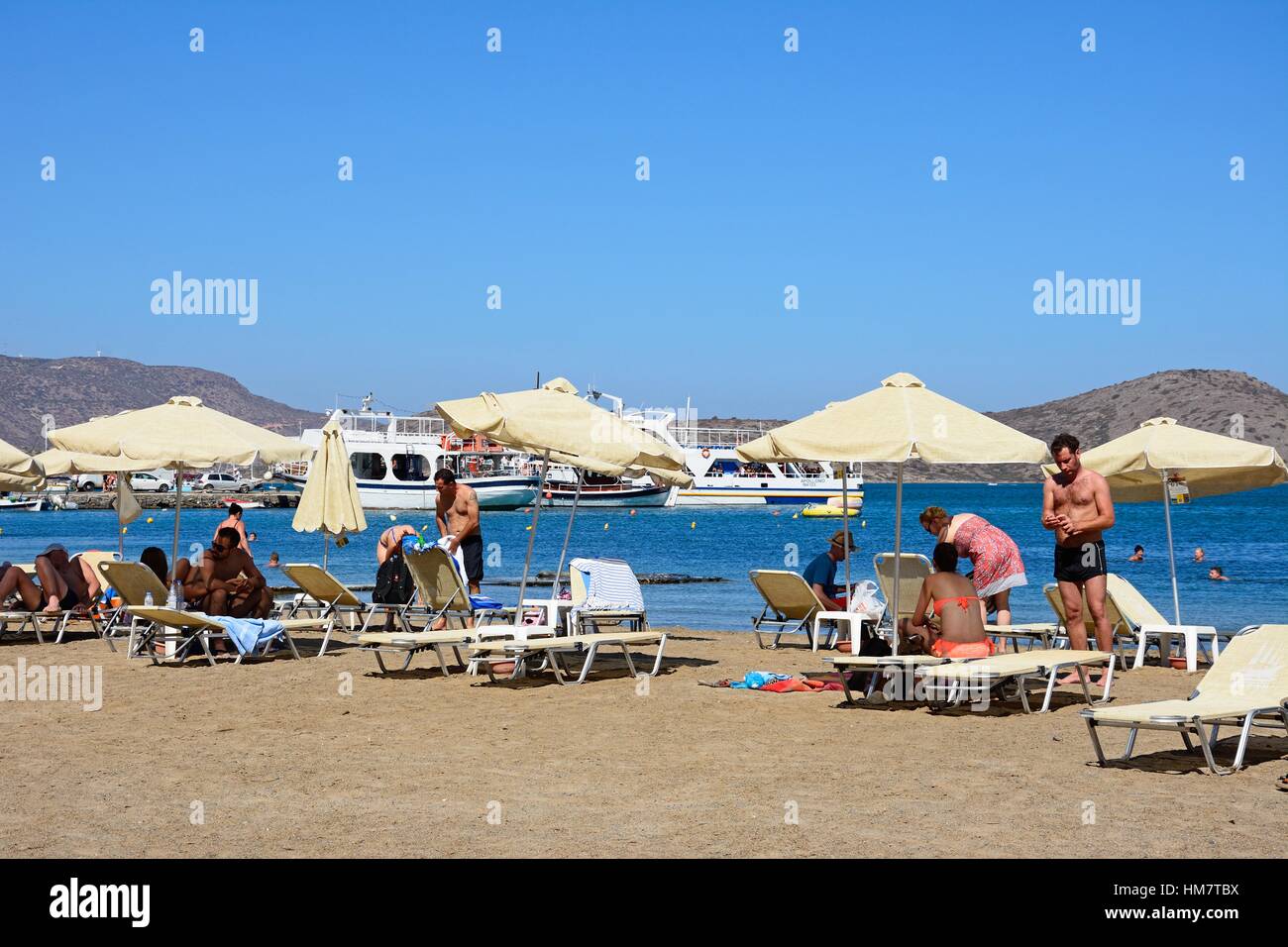 Tourists relaxing on the beach, Elounda, Crete, Greece, Europe Stock ...