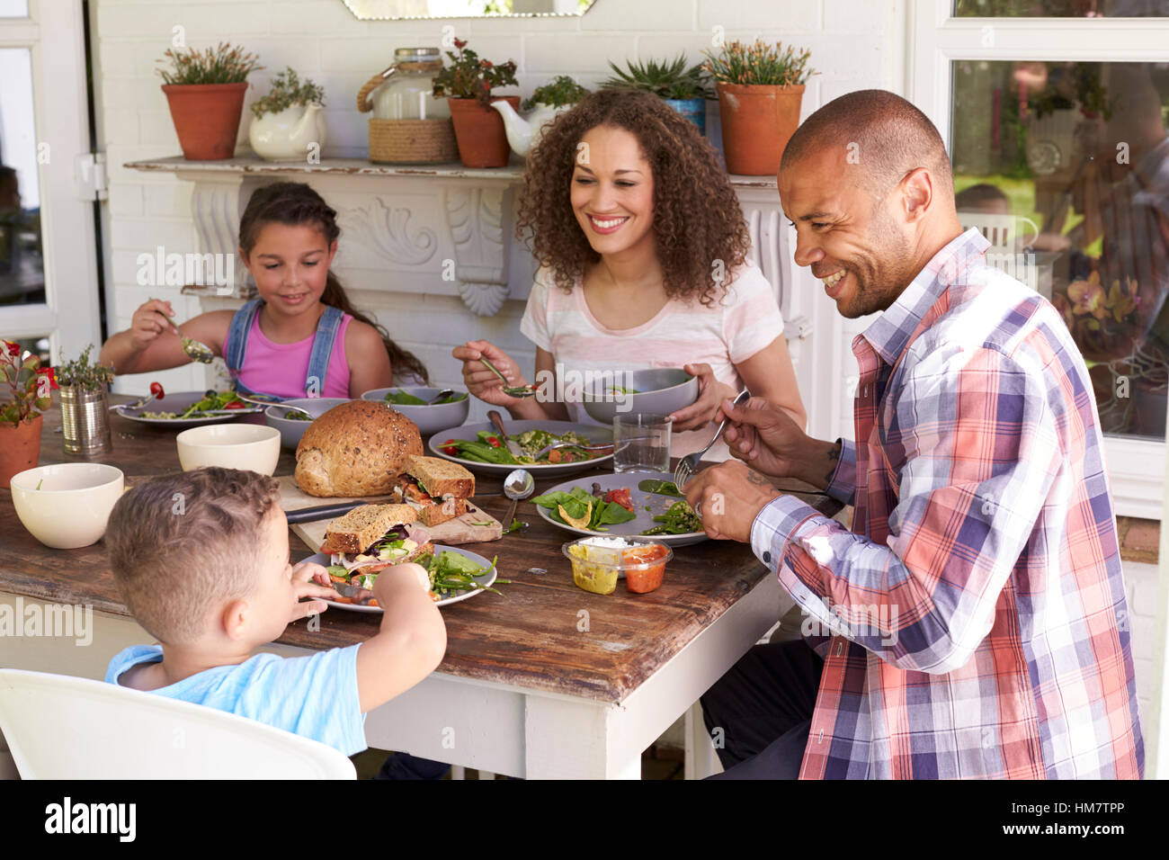 Family At Home Eating Outdoor Meal Together Stock Photo - Alamy