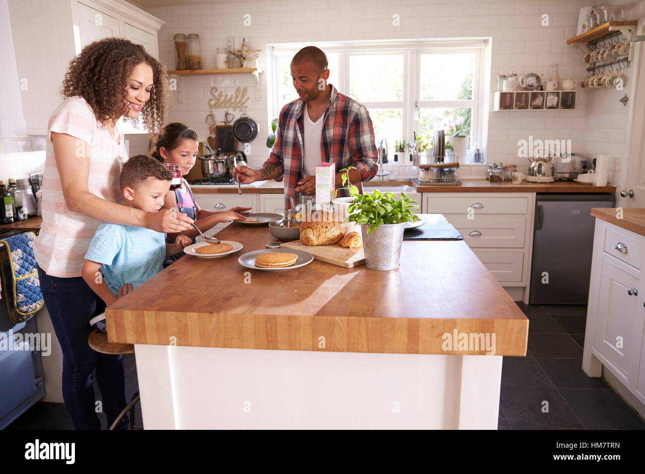 Family At Home Eating Breakfast In Kitchen Together Stock Photo - Alamy