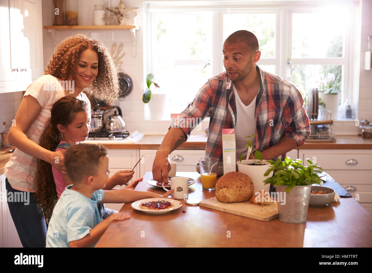 Family At Home Eating Breakfast In Kitchen Together Stock Photo - Alamy