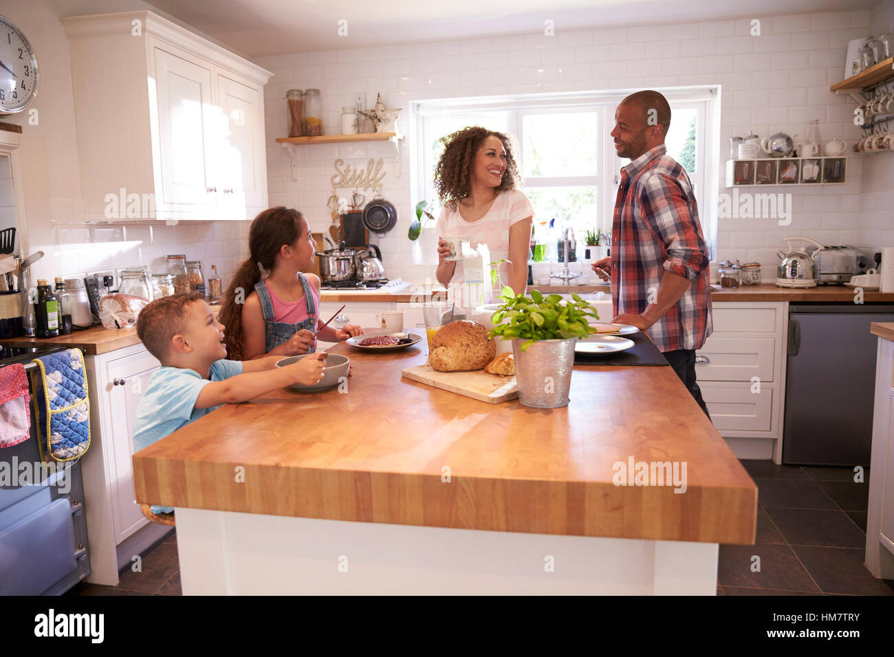 Family At Home Eating Breakfast In Kitchen Together Stock Photo - Alamy