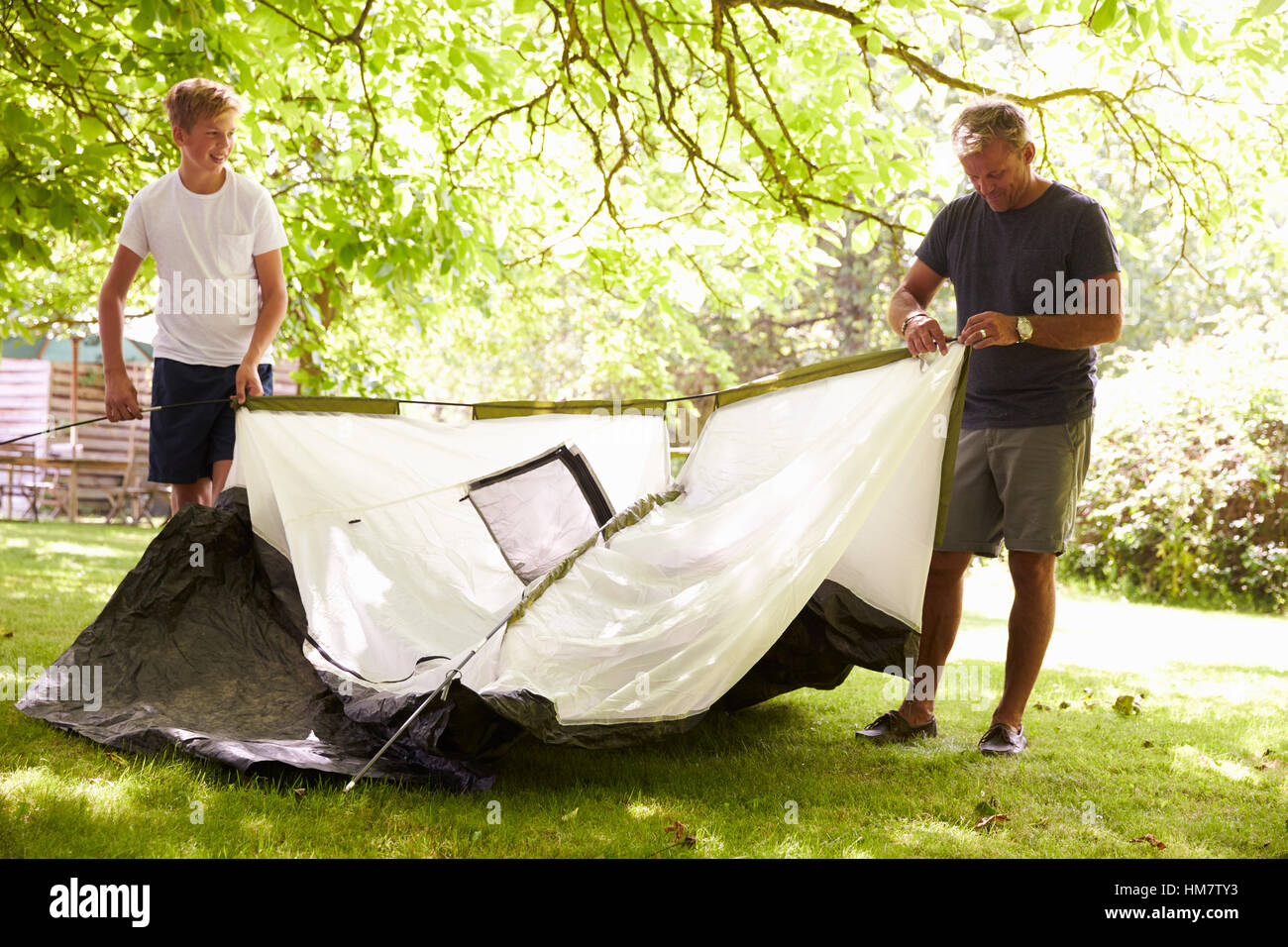 Father And Teenage Son Putting Up Tent On Camping Trip Stock Photo - Alamy