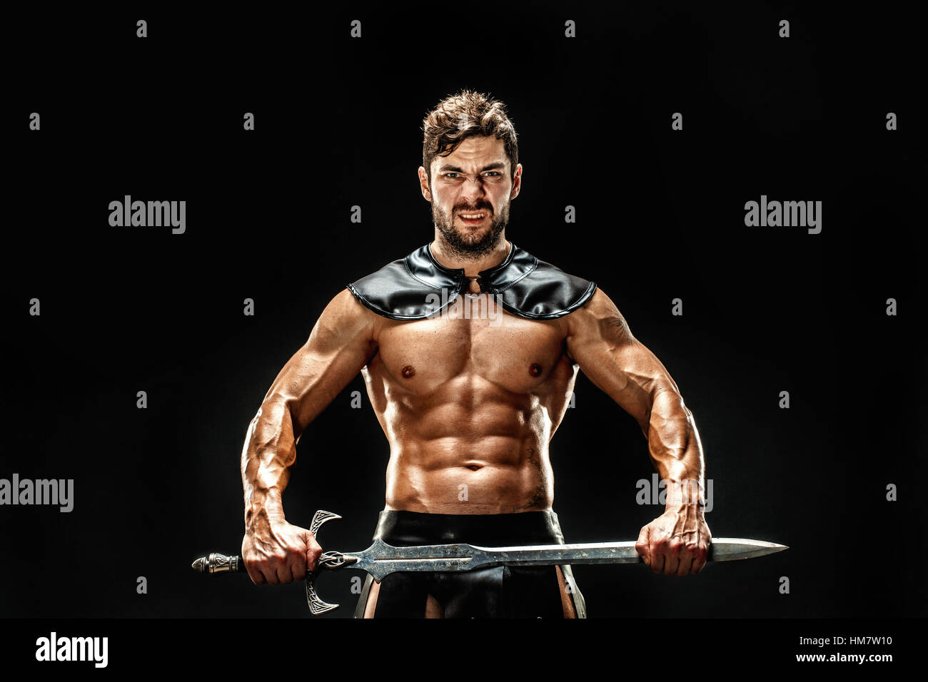 Severe barbarian in leather costume with sword Stock Photo - Alamy