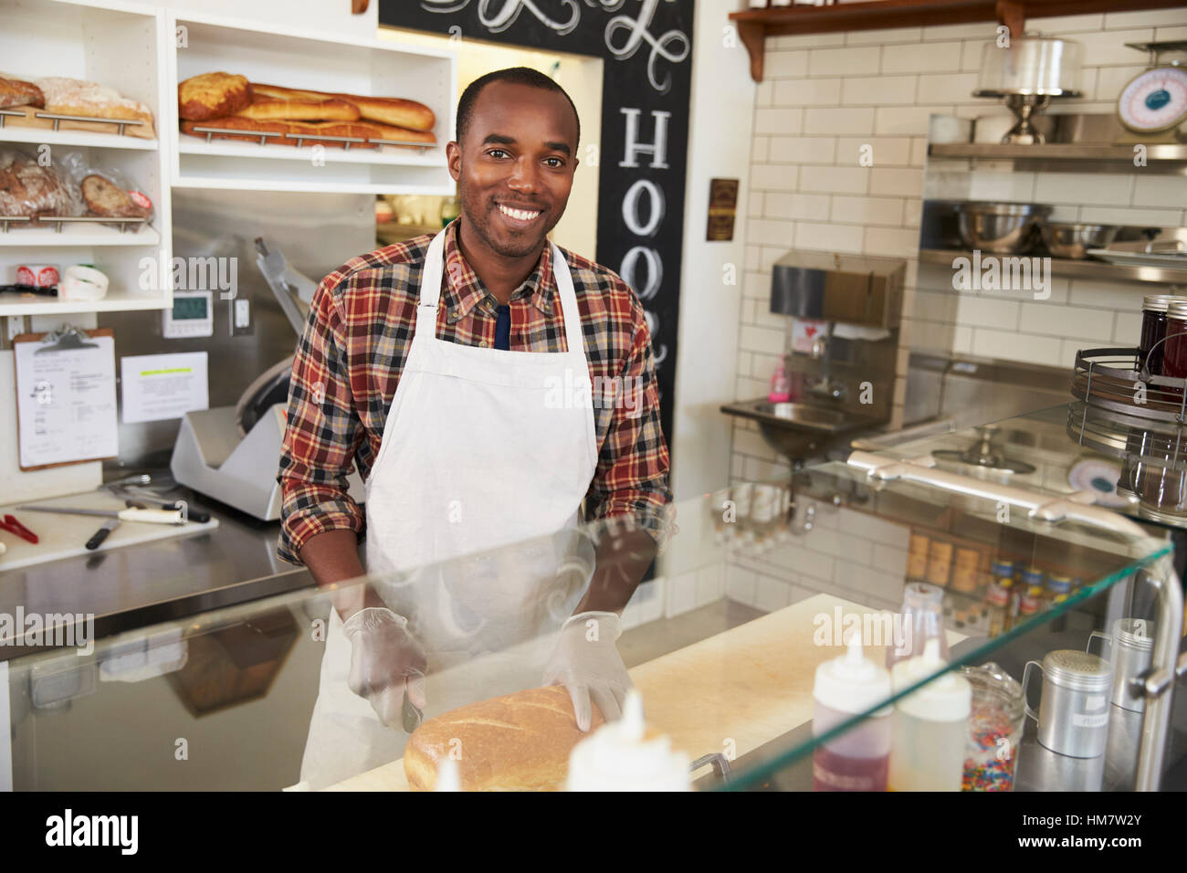 Deli shop counter bread man hi-res stock photography and images - Alamy