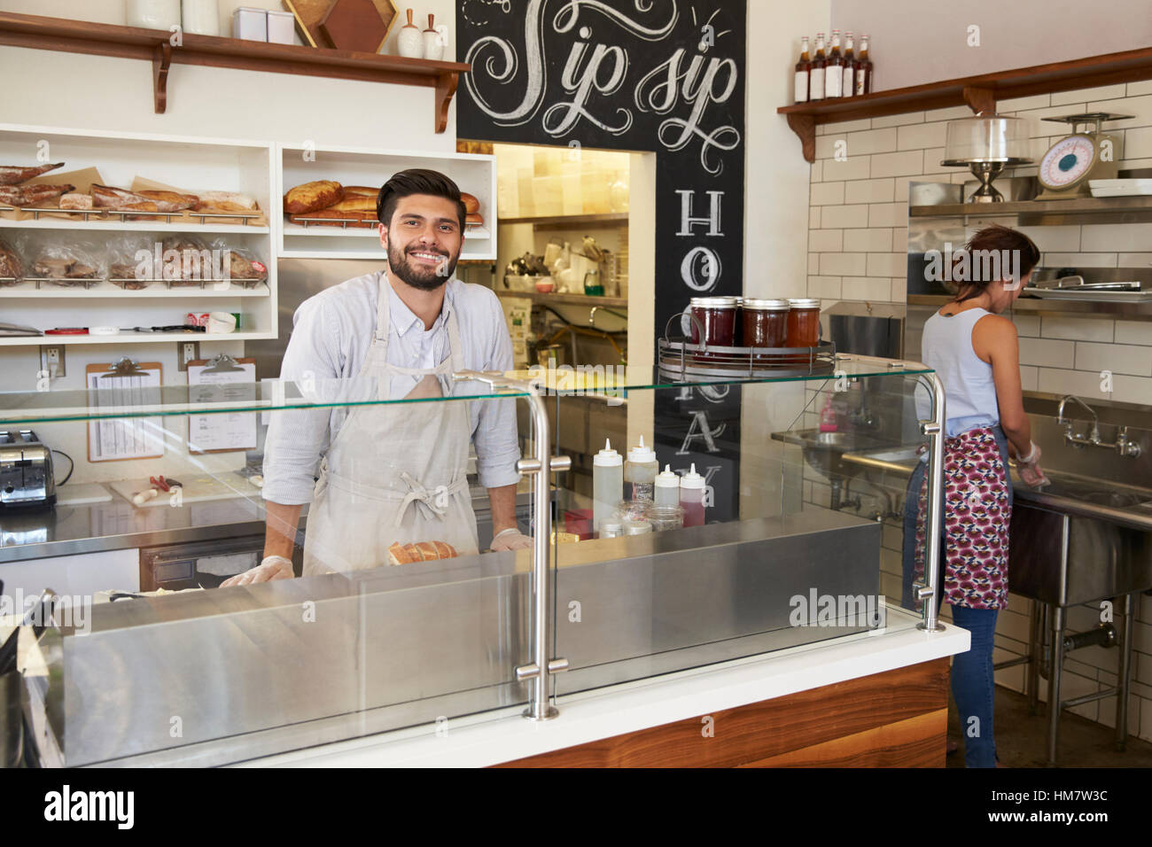 Staff working behind the counter at a sandwich bar Stock Photo - Alamy