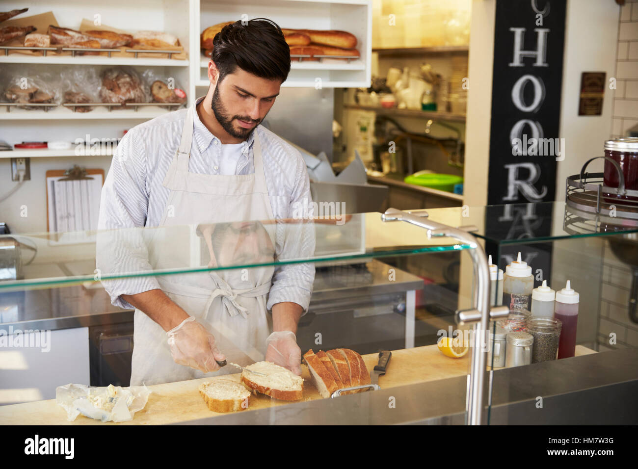 Deli shop counter bread man hi-res stock photography and images - Alamy