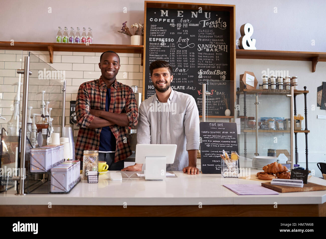 Business partners stand behind the counter at a coffee shop Stock Photo ...