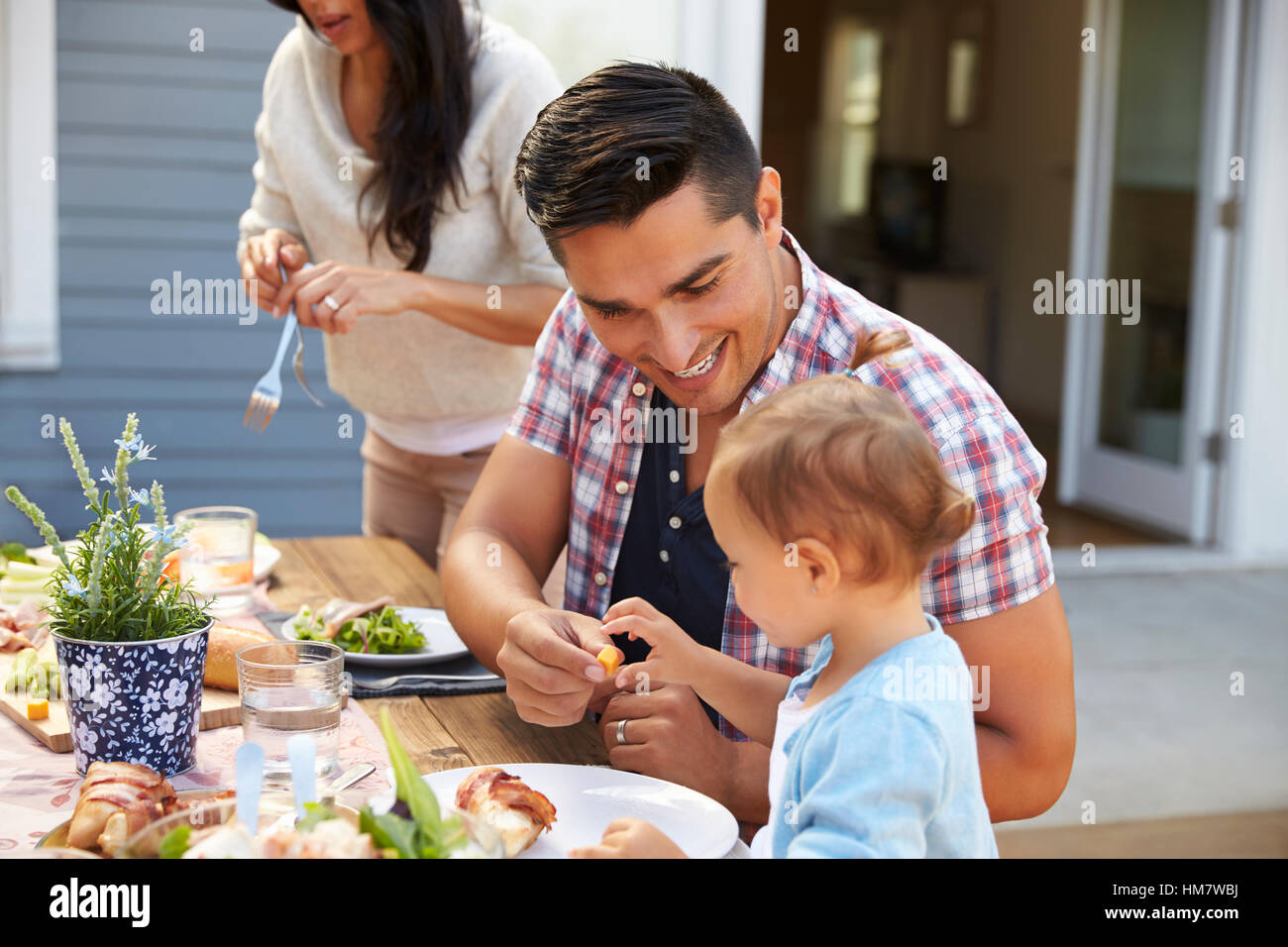 Family At Home Eating Outdoor Meal In Garden Together Stock Photo - Alamy