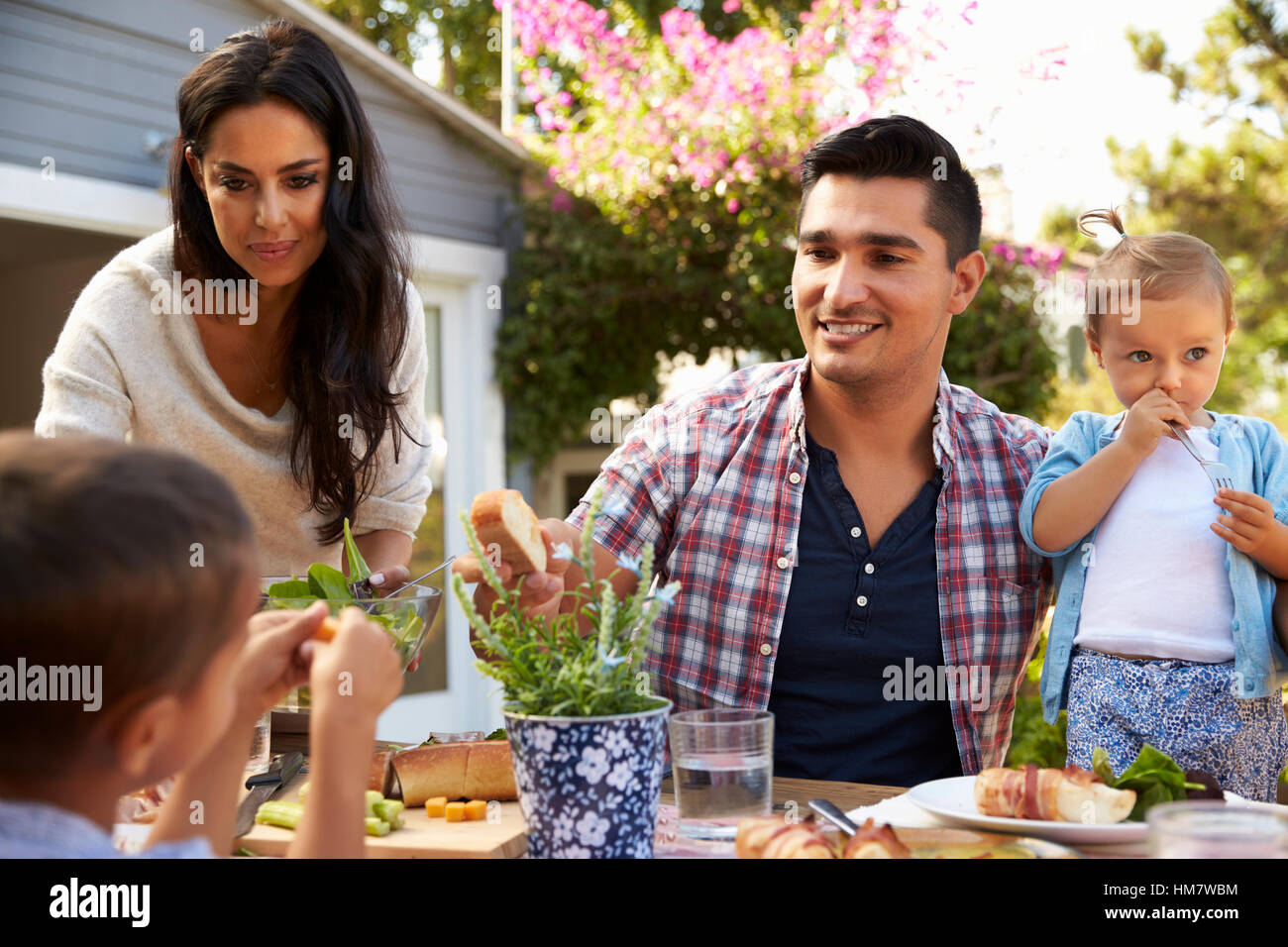 Family At Home Eating Outdoor Meal In Garden Together Stock Photo - Alamy