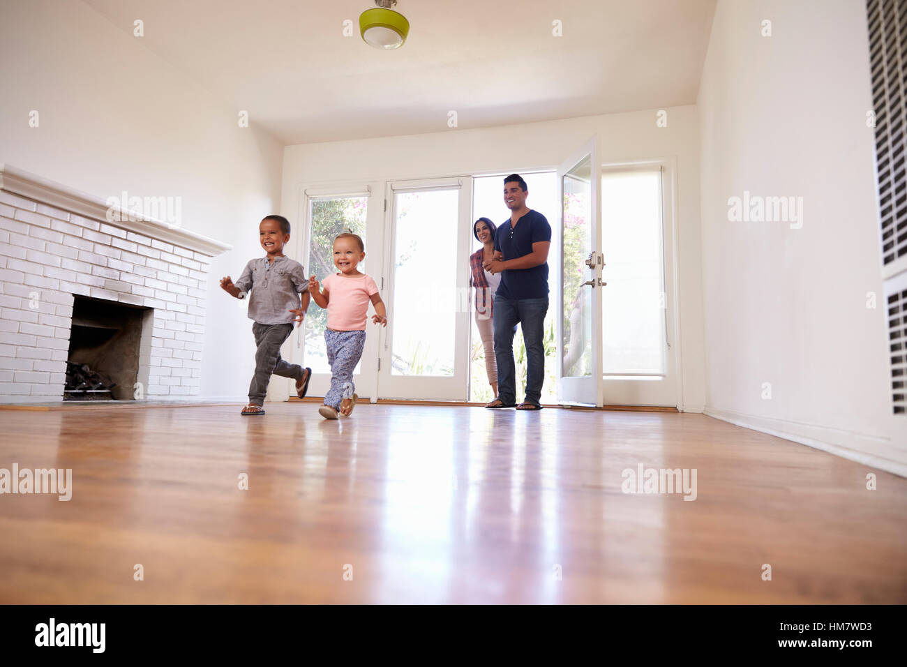 Excited Family Explore New Home On Moving Day Stock Photo - Alamy