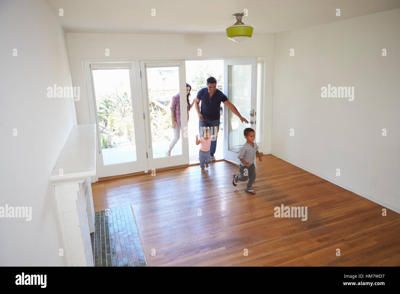 High Angle View Of Family Exploring New Home On Moving Day Stock Photo ...