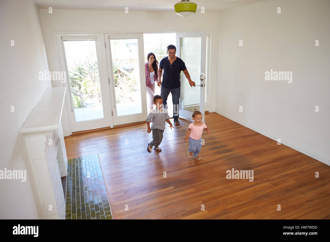 High Angle View Of Family Exploring New Home On Moving Day Stock Photo ...