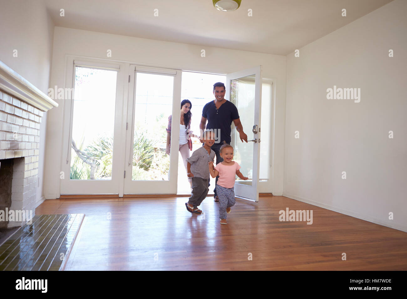 Excited Family Explore New Home On Moving Day Stock Photo - Alamy
