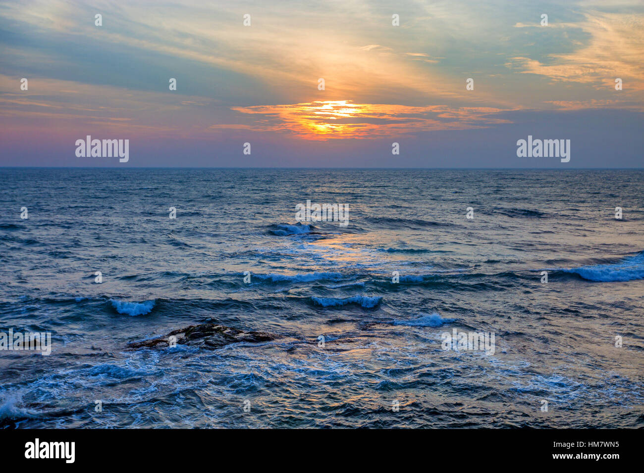 Sunset on tropical coastline Stock Photo - Alamy
