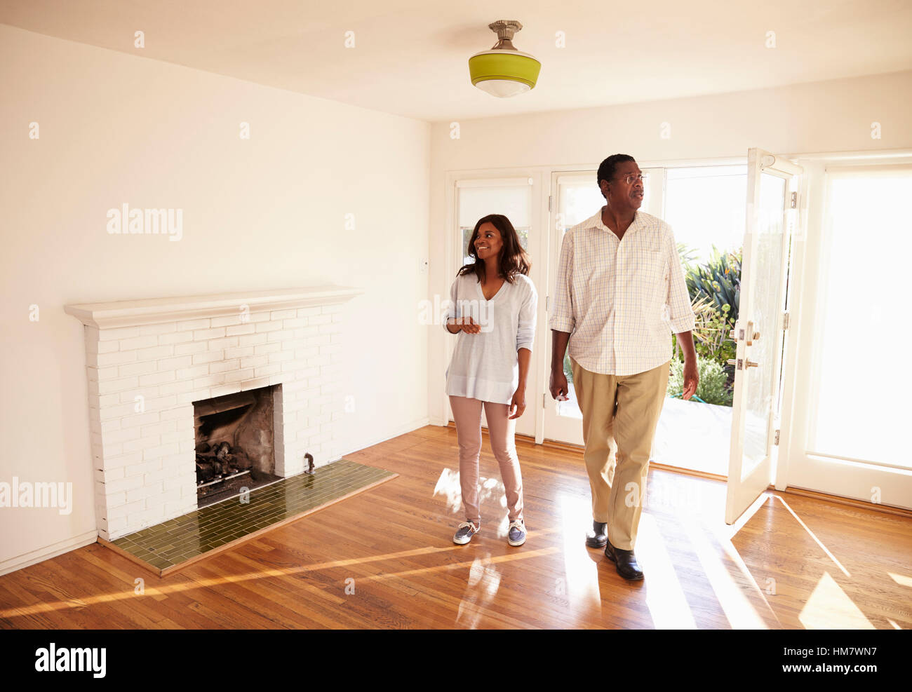 Excited Couple Explore New Home On Moving Day Stock Photo - Alamy