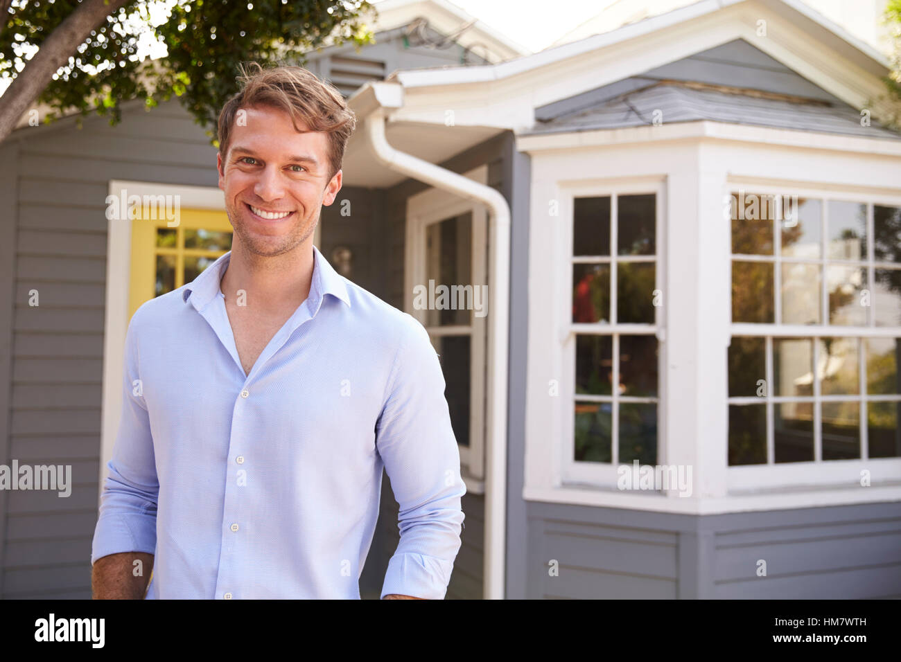 Portrait Of Man Standing Outside New Home Stock Photo - Alamy