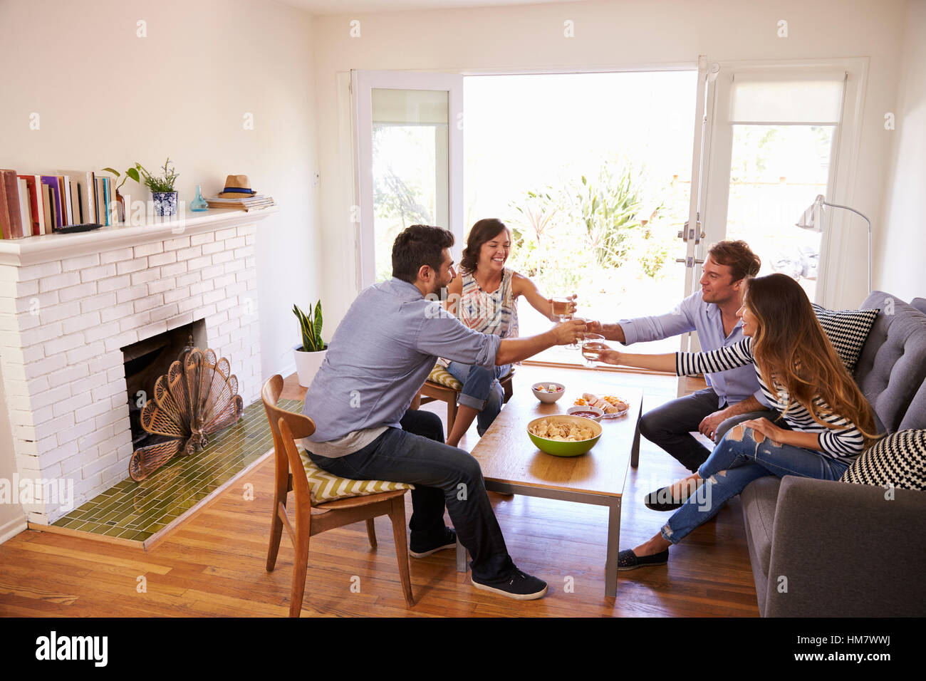 Couple Entertaining Friends At Home Stock Photo - Alamy