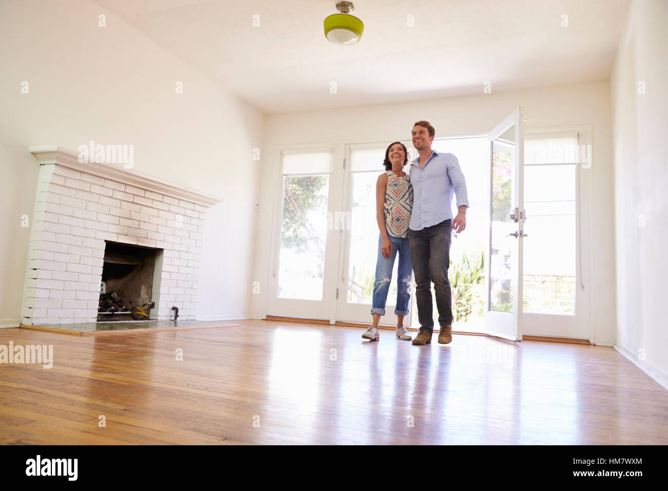 Excited Couple Explore New Home On Moving Day Stock Photo - Alamy