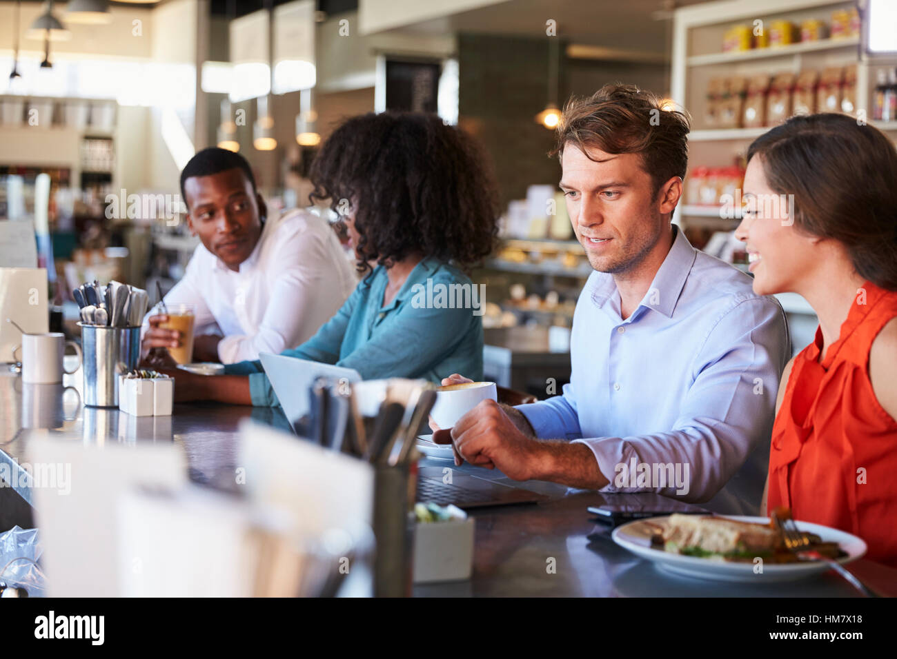 Group Enjoying Business Lunch At Delicatessen Counter Stock Photo - Alamy