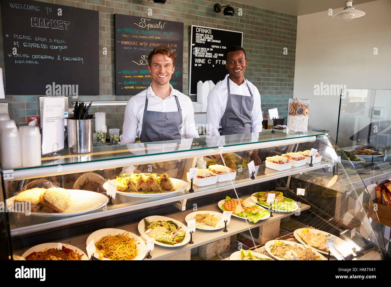 Male Staff Working Behind Counter In Delicatessen Stock Photo - Alamy