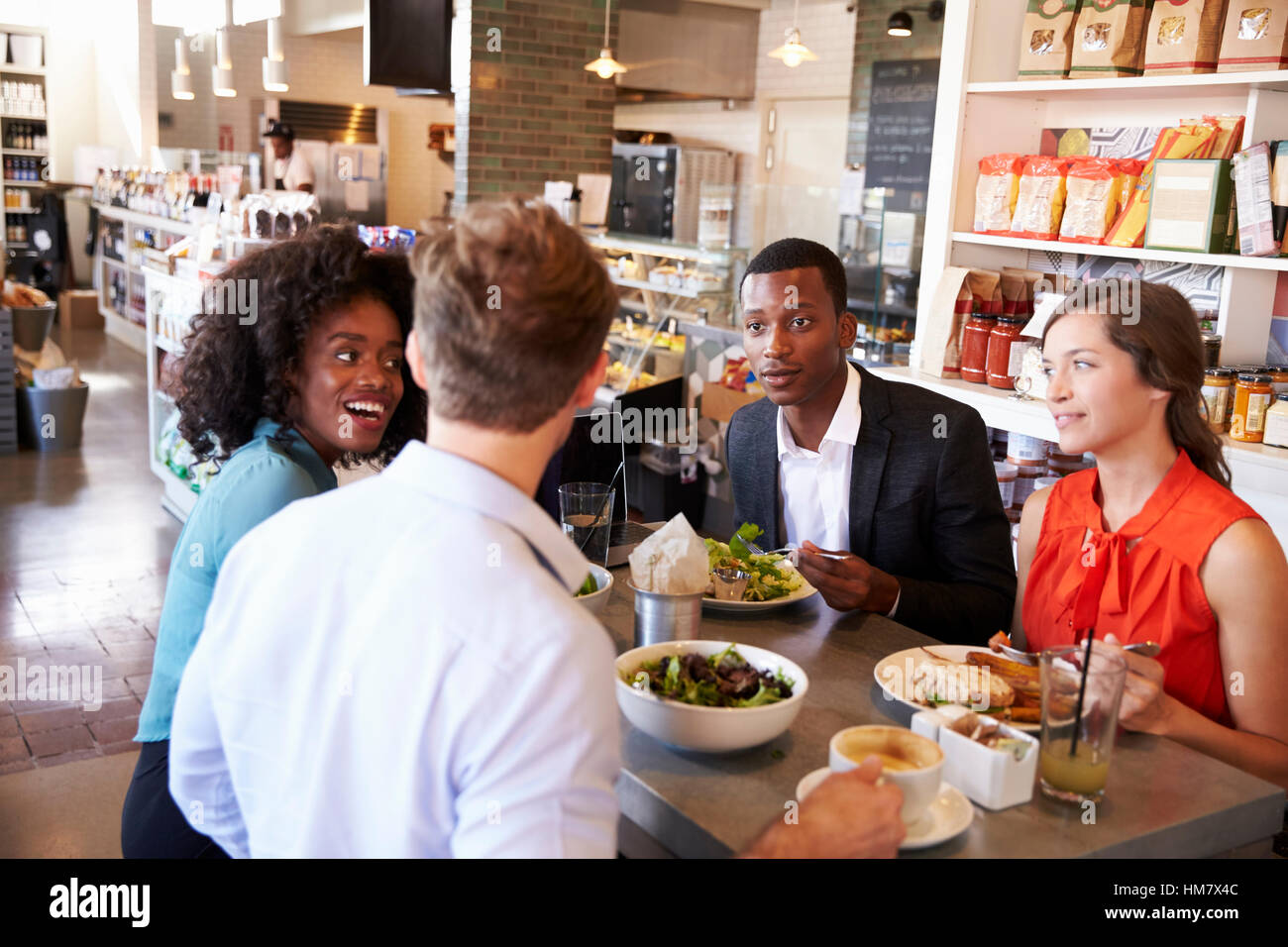 Group Enjoying Business Lunch In Delicatessen Stock Photo - Alamy