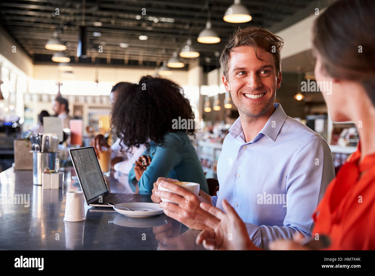Business People Working At Counter In Coffee Shop Stock Photo - Alamy