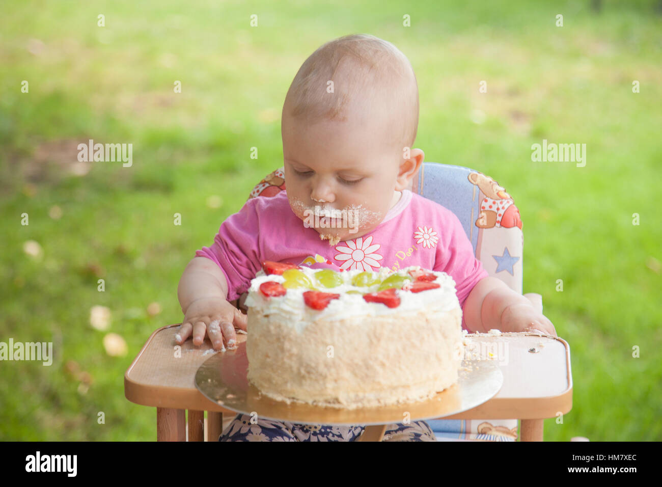 A Baby Eating Birthday Cake With Her Hands Stock Photo - Alamy