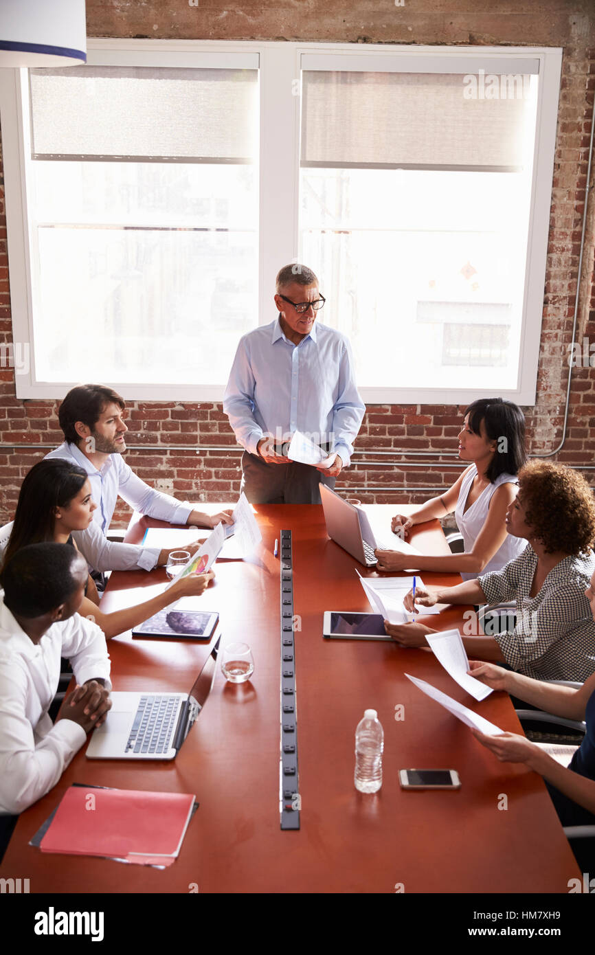 Mature Businessman Addressing Boardroom Meeting Stock Photo - Alamy