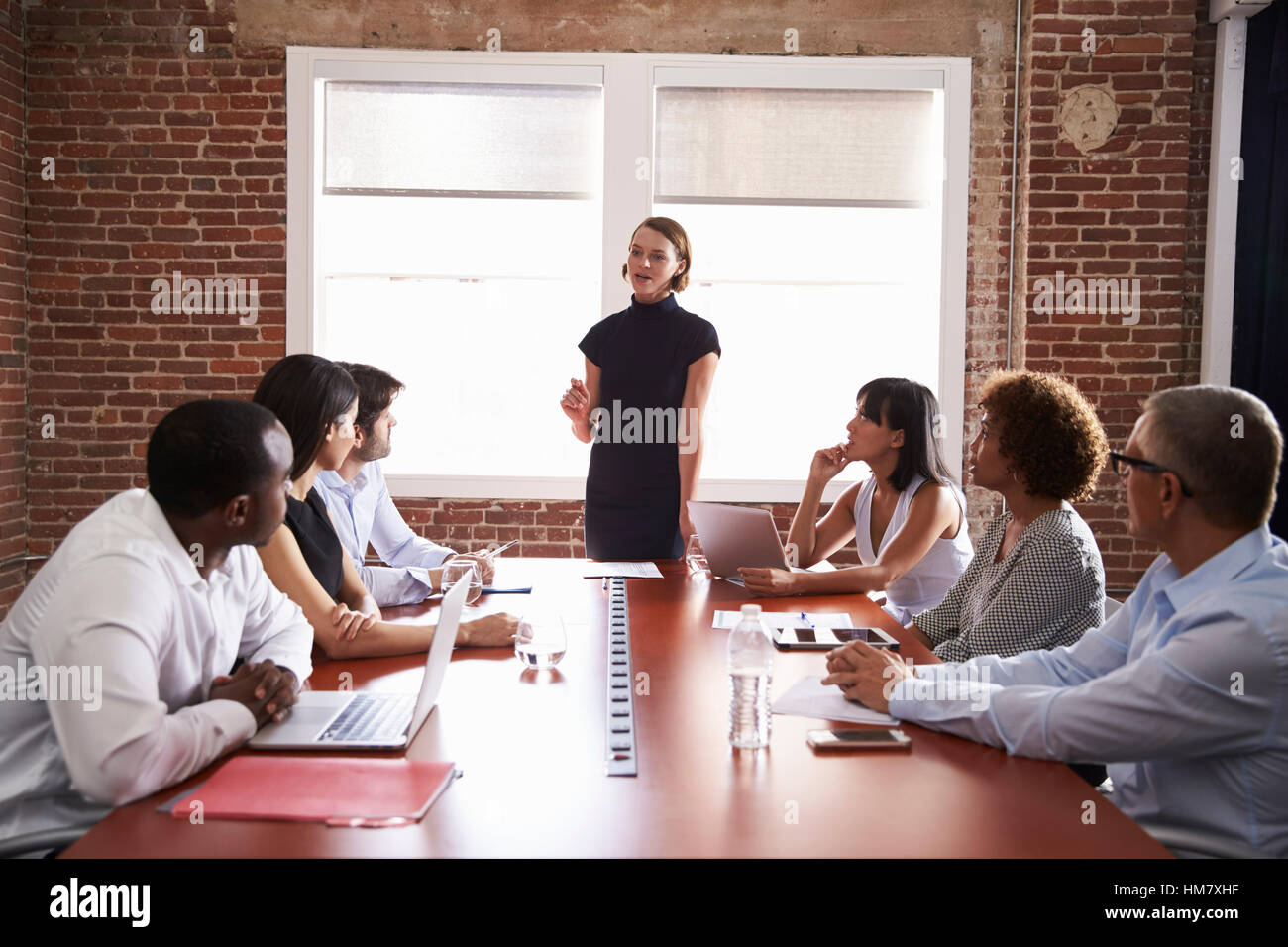 Young Businesswoman Addressing Boardroom Meeting Stock Photo - Alamy