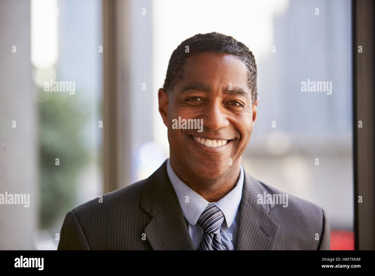 Middle aged black businessman smiling to camera Stock Photo - Alamy