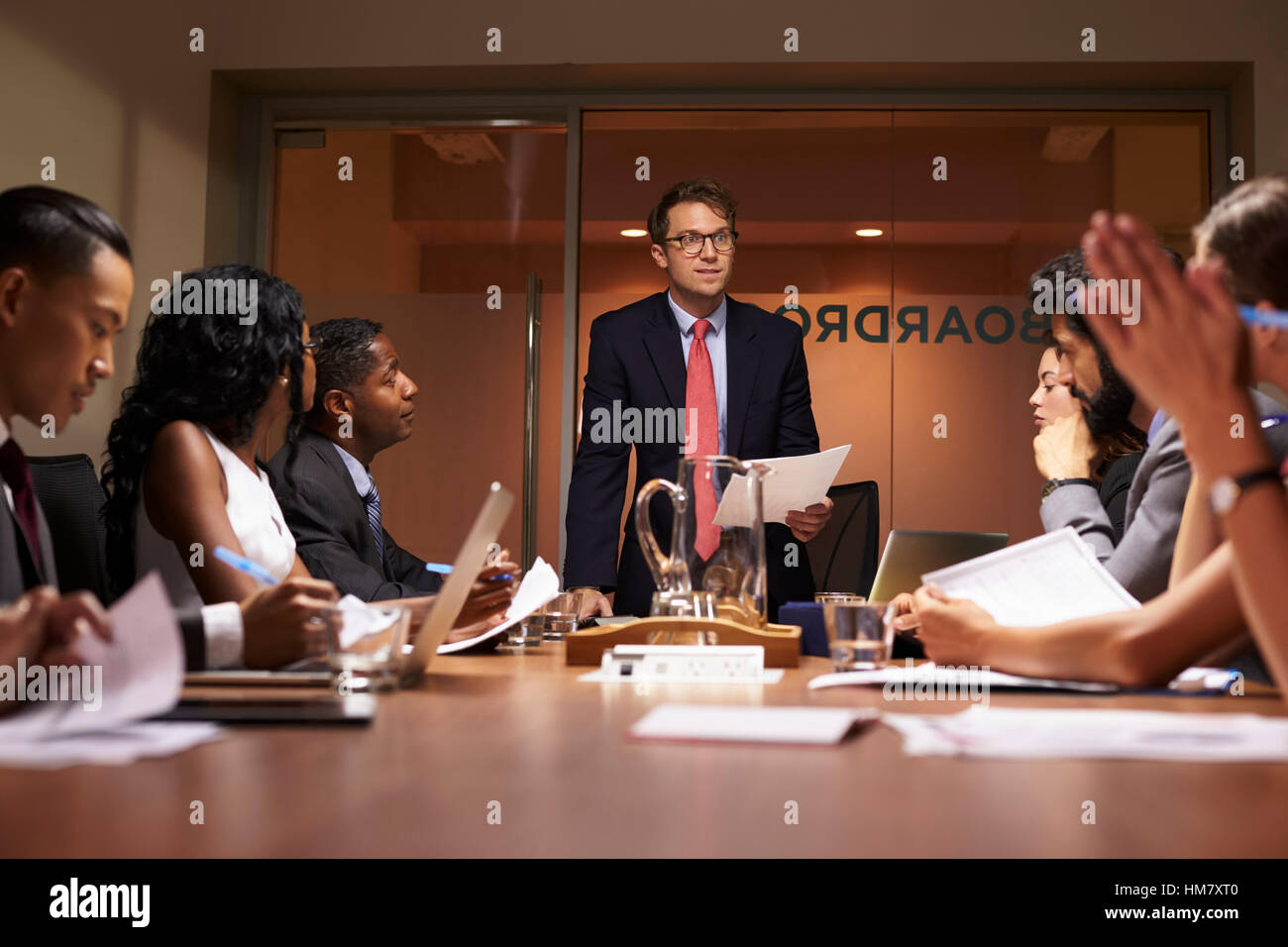 Businessman stands addressing team at meeting, low angle Stock Photo ...