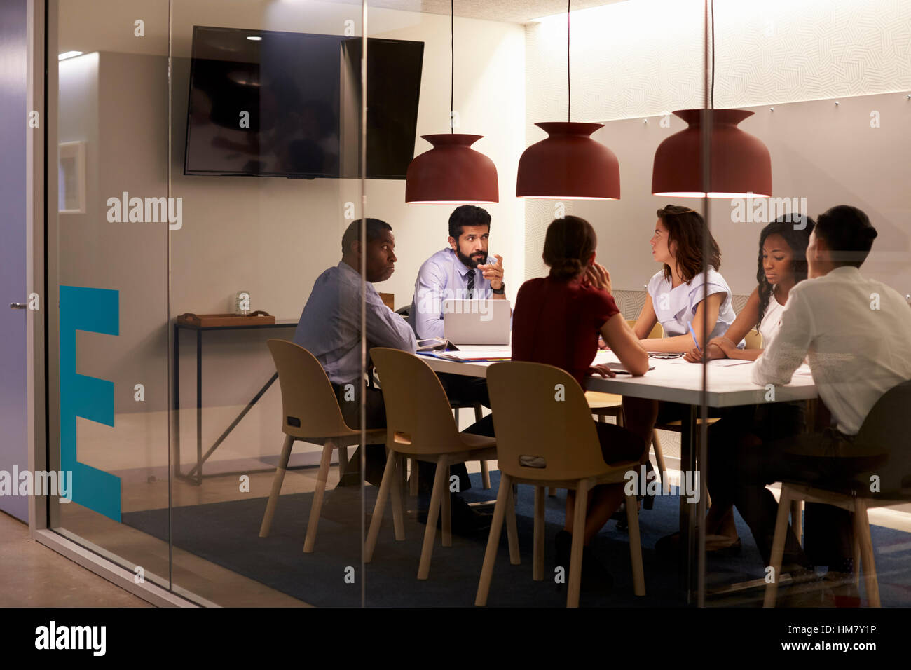 Corporate team at table in a meeting room cubicle, close up Stock Photo ...
