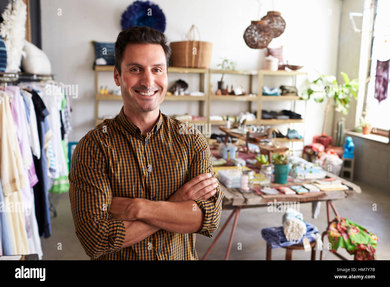 Young male business owner in clothes shop hi-res stock photography and ...