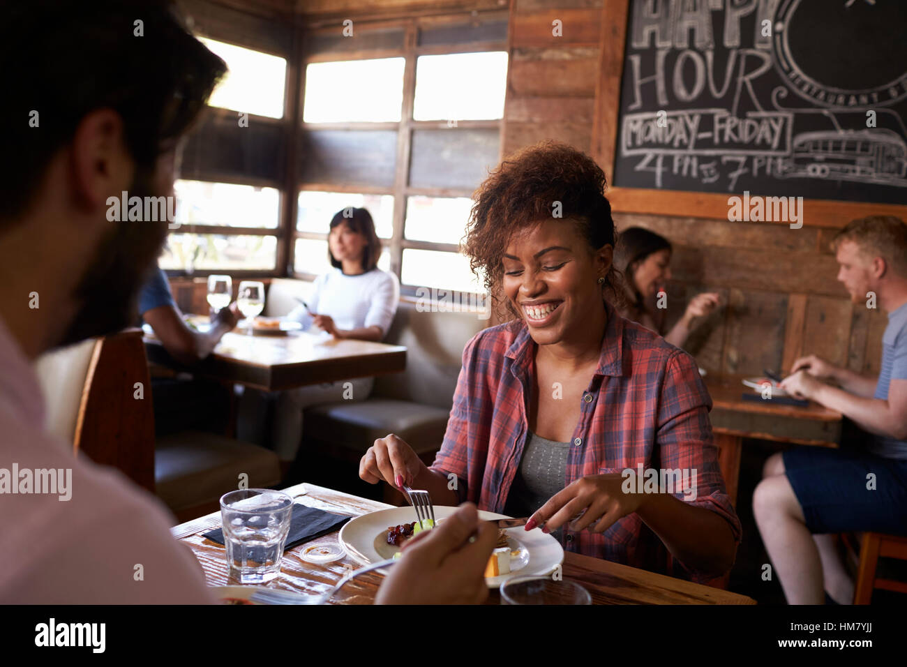 Mixed race couple having lunch in busy restaurant, close up Stock Photo ...