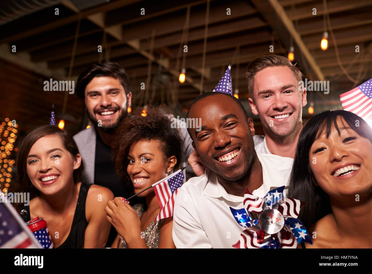 Friends with US flags at a 4th July party in a bar, close up Stock ...