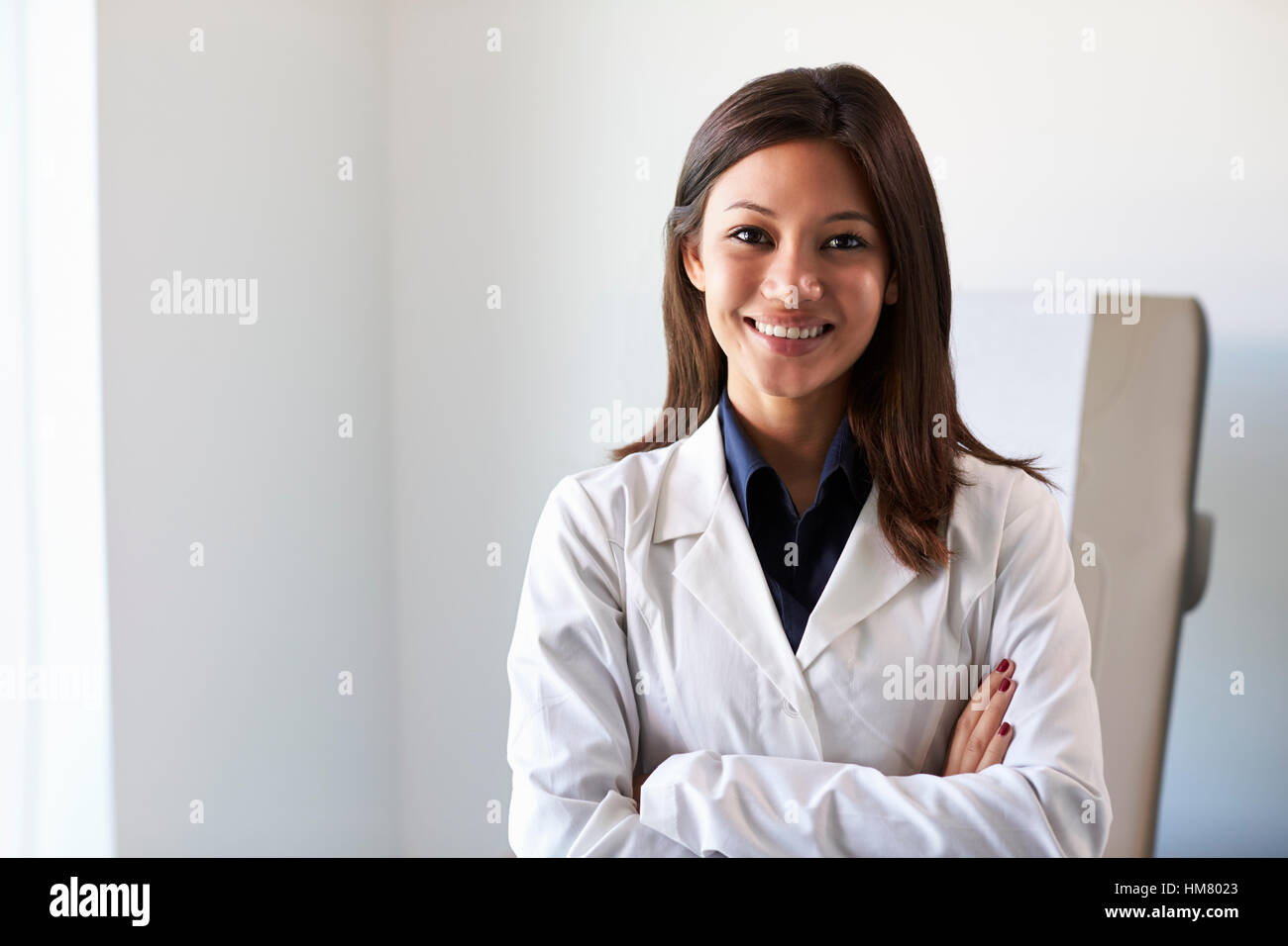 Portrait Of Female Doctor Wearing White Coat In Exam Room Stock Photo ...