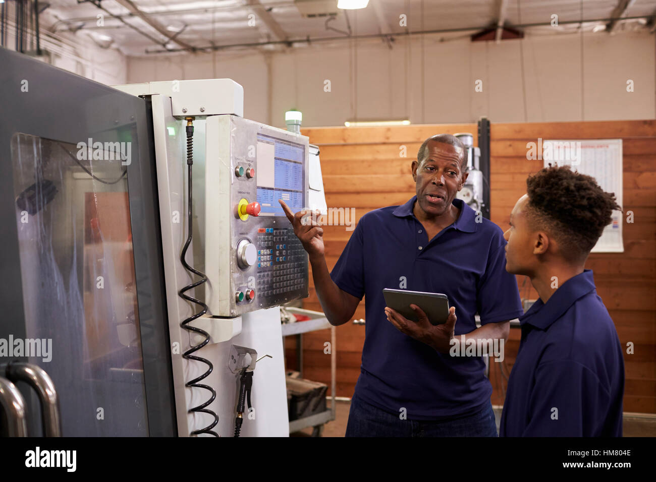 Engineer Training Young Male Apprentice On CNC Machine Stock Photo - Alamy