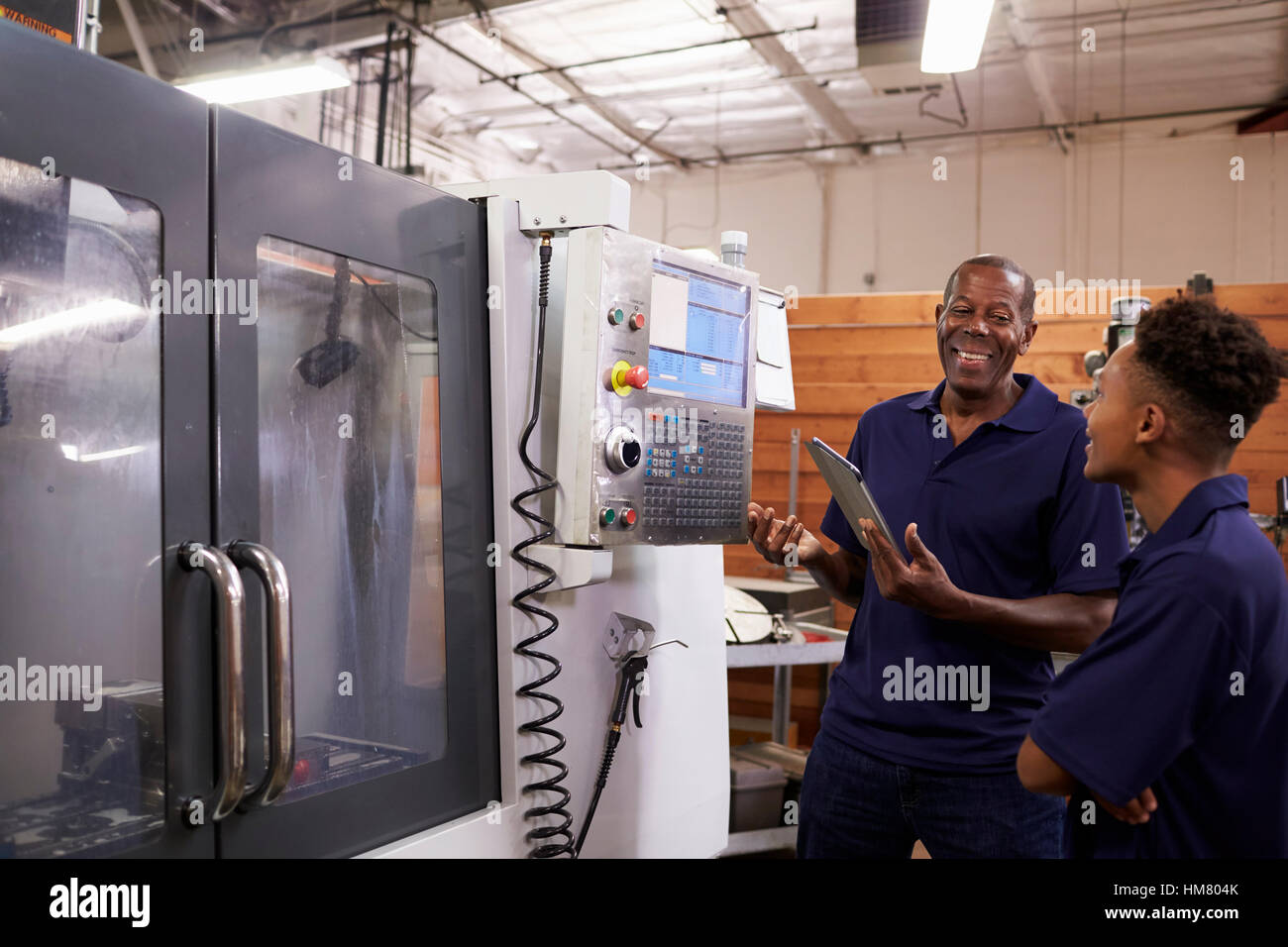 Engineer Training Young Male Apprentice On CNC Machine Stock Photo - Alamy