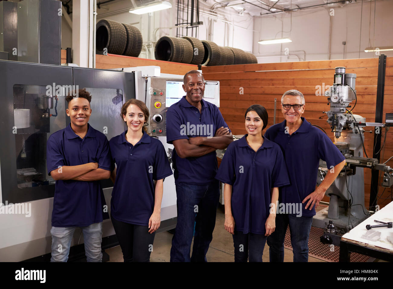 Portrait Of Engineers And Apprentices With CNC Machine Stock Photo - Alamy