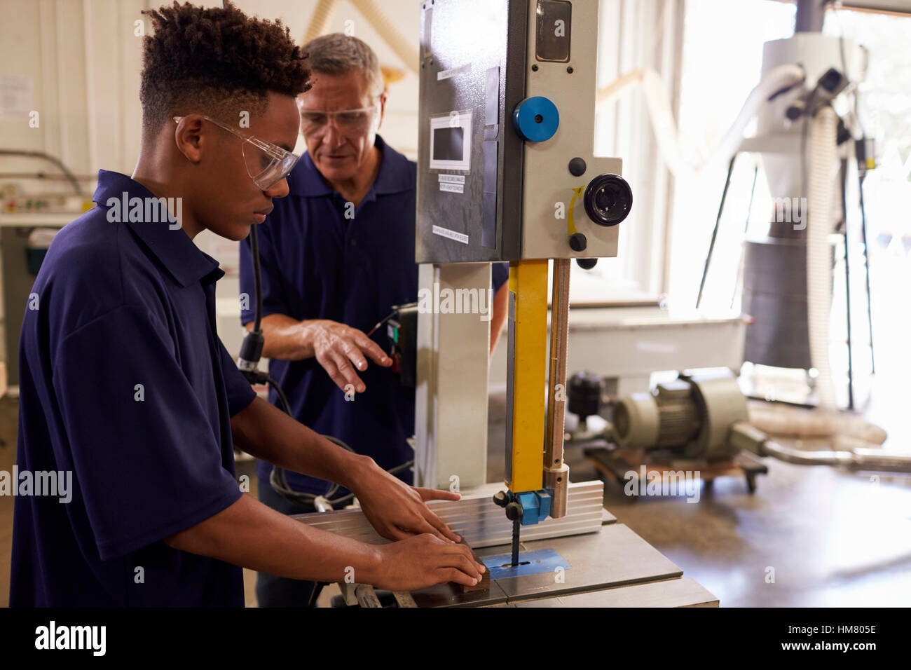 Carpenter Training Male Apprentice To Use Mechanized Saw Stock Photo ...