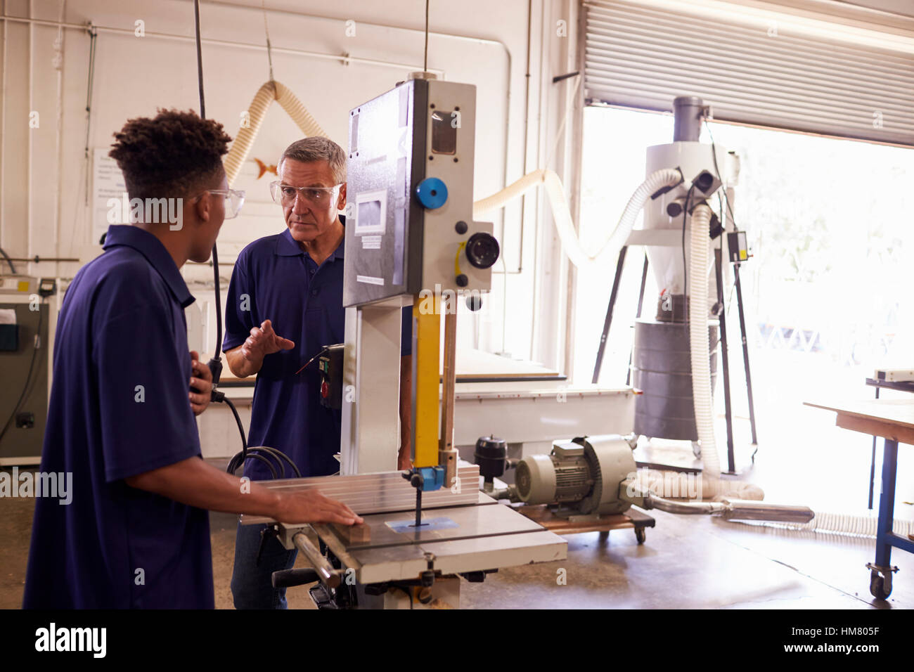 Carpenter Training Male Apprentice To Use Mechanized Saw Stock Photo ...