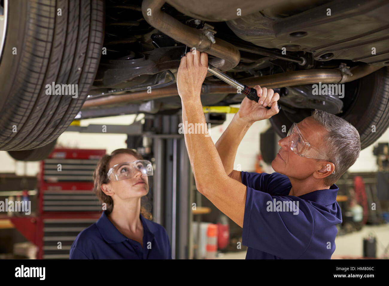 Mechanics working underneath car hi-res stock photography and images - Alamy