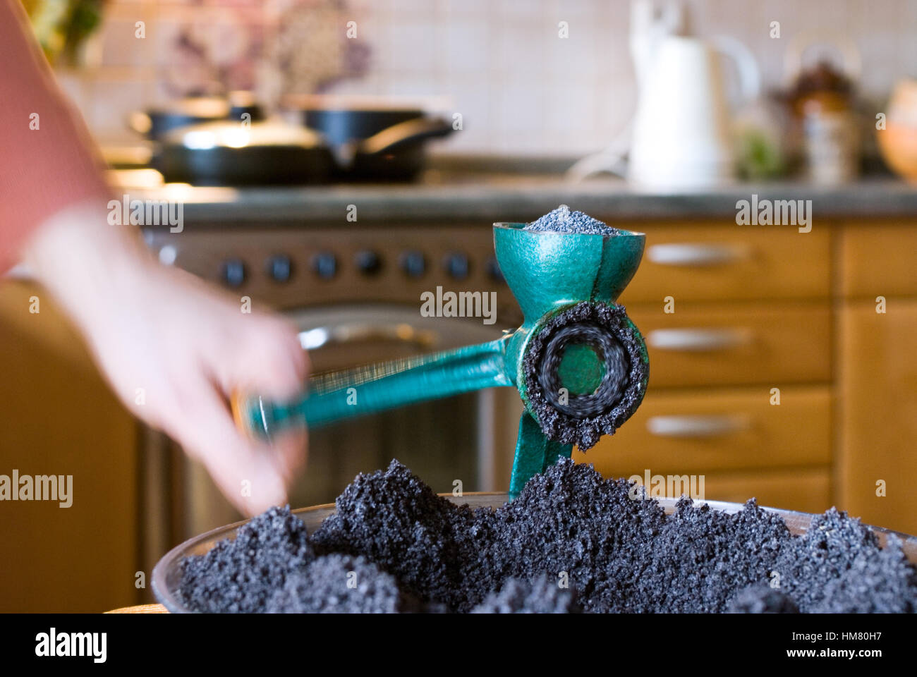 Chef grinds poppy with poppy seed grinder Stock Photo - Alamy