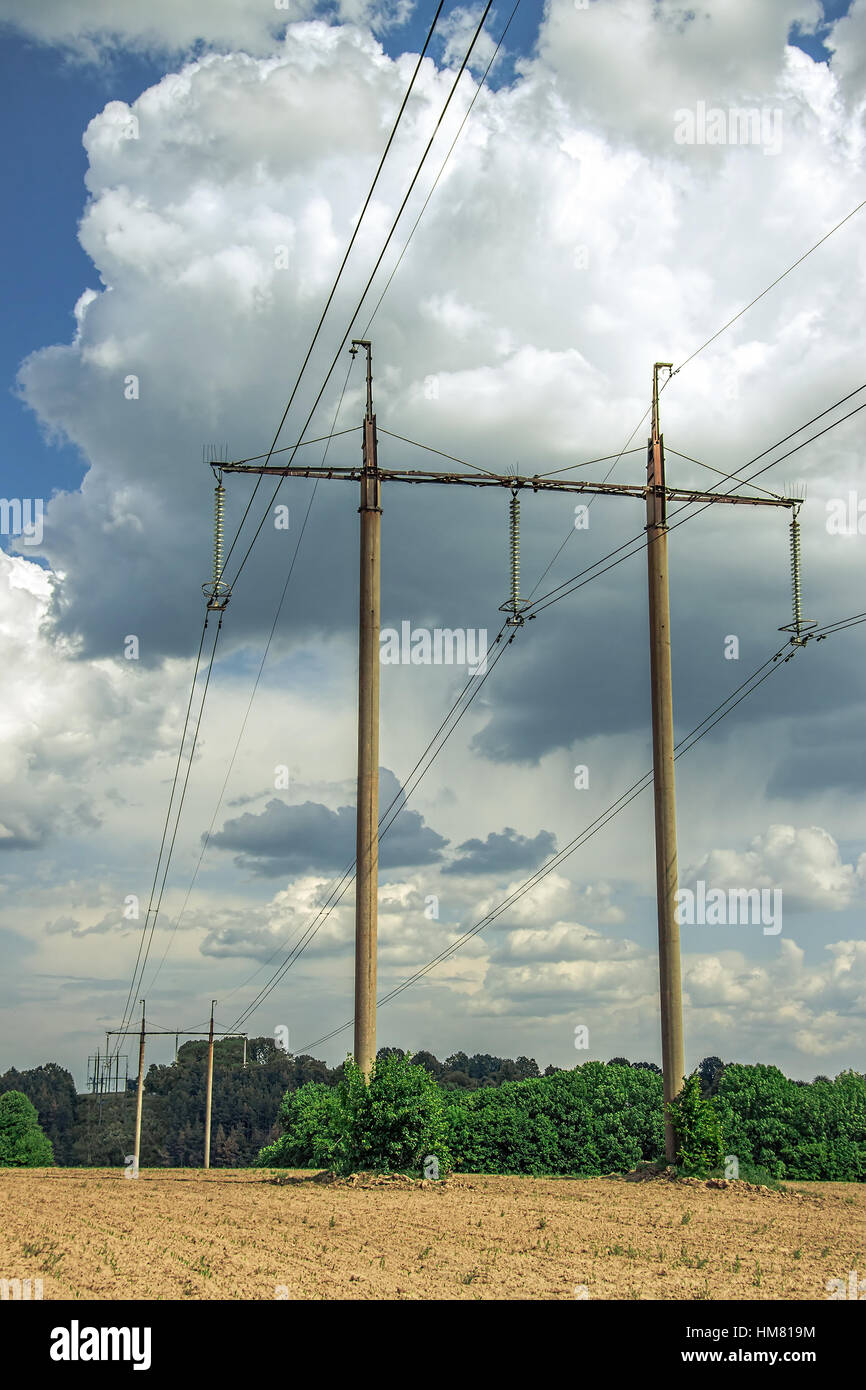 Power lines in the countryside landscape in sunmmer with clouds in the ...