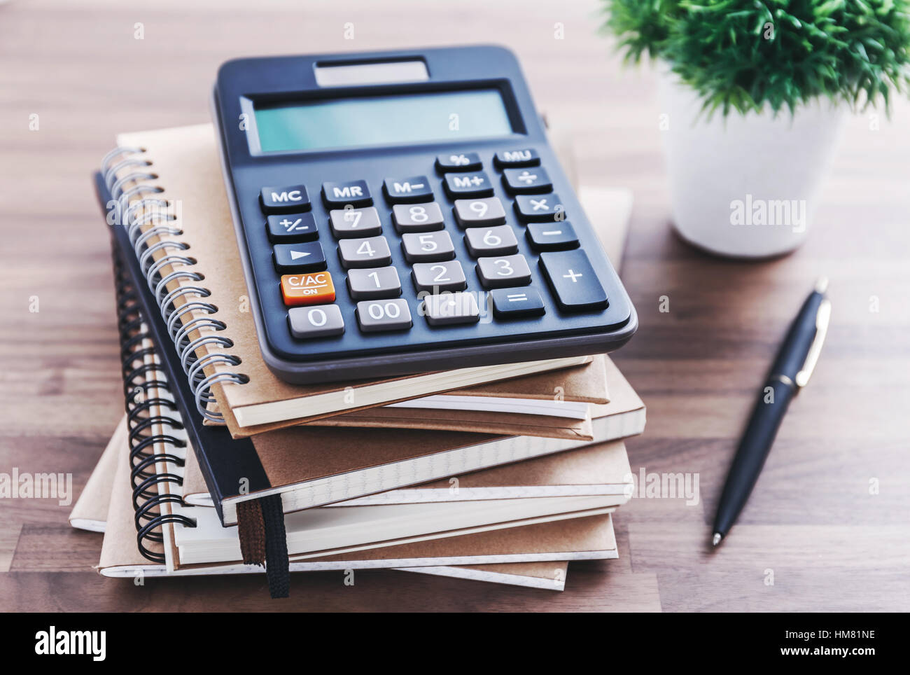 Calculator with notebook and pen on office desk Stock Photo - Alamy