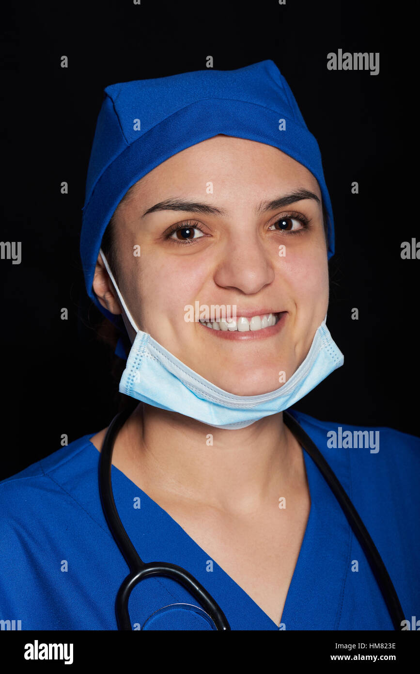 doctor smiling on a black background and with mask on her neck Stock ...