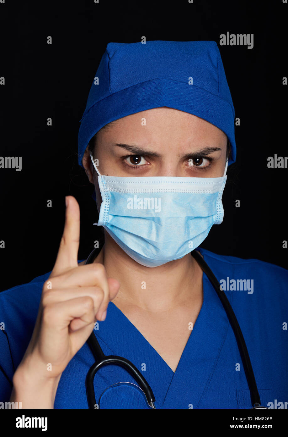 portrait of warning woman doctor isolated on black background Stock ...