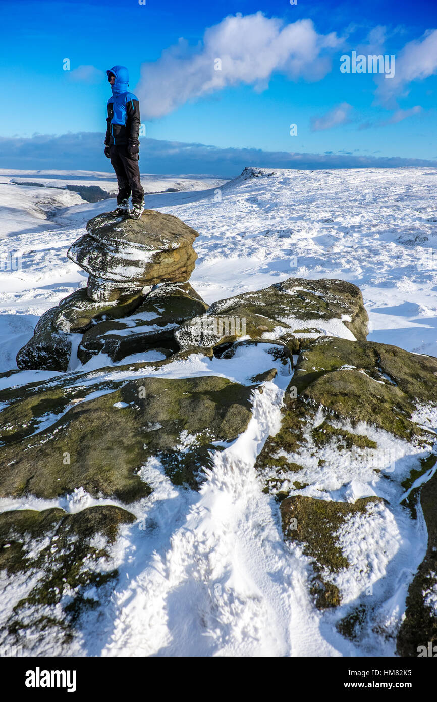 A male hill walker on Kinder Scout in winter, Peak District National ...